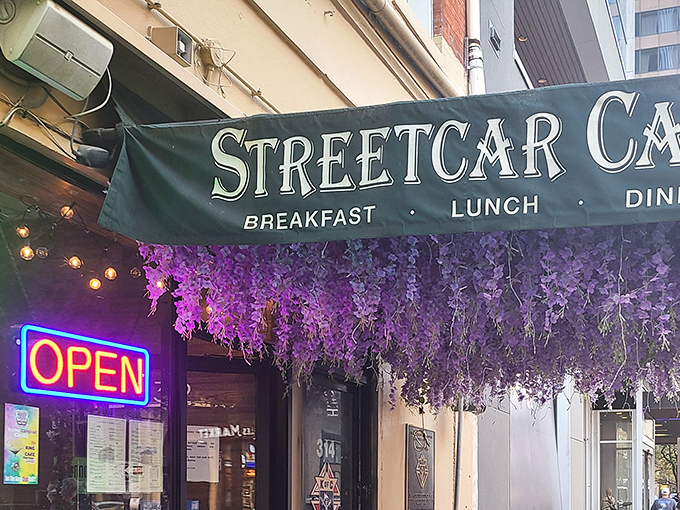That NEON says "OPEN" but the purple flowers scream "come inside and treat yourself to something special!"