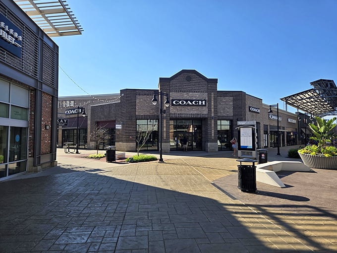 Brick, benches, and bargains as far as the eye can see. Coach's storefront beckons like a siren song to passing shoppers.