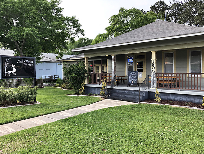 A slice of Mississippi magic where the grass is green and the BBQ is serious. That porch practically whispers "come sit a spell."