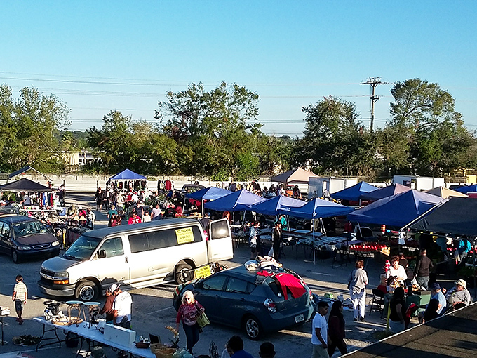 Blue tents dot the landscape like sails on an ocean of bargains, with shoppers navigating currents of merchandise under Florida's perfect sky.