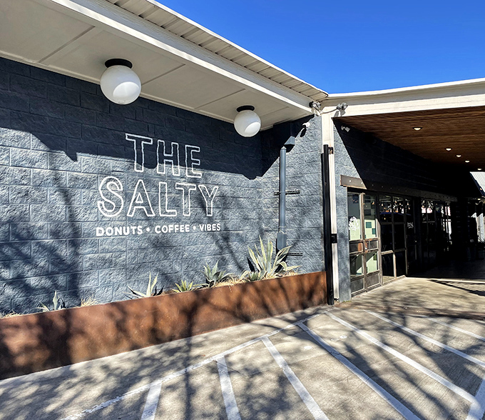 "DONUTS &bull; COFFEE &bull; VIBES" isn't just a sign&mdash;it's a life philosophy. The Salty Donut's modern storefront promises a trifecta of morning essentials.