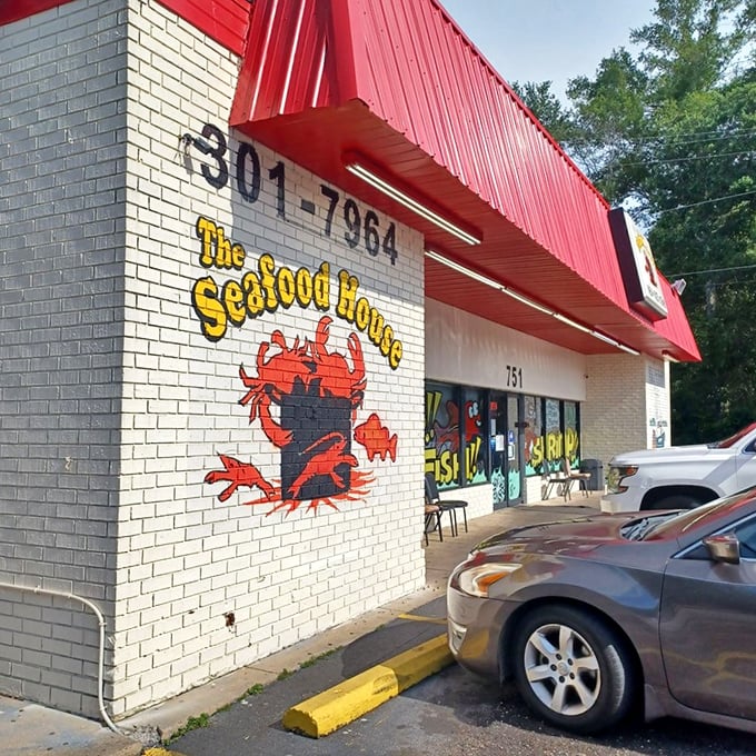 That cheerful red crab mural tells you everything: serious seafood lives behind these humble brick walls.