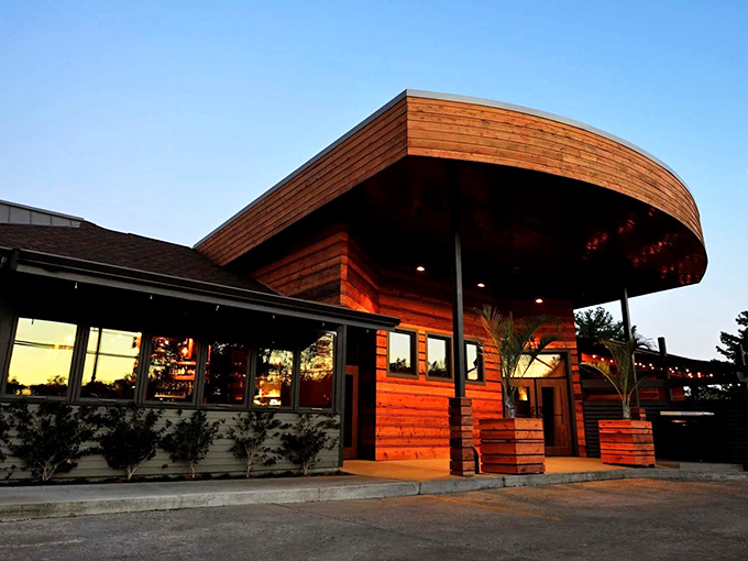 Urban Grub (exterior evening): "Sunset magic at Urban Grub. That curved wooden overhang isn't just architectural showing off—it's practically begging you to dine al fresco."