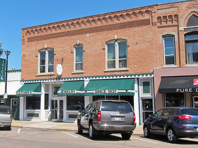Green awnings and brick facades tell stories of simpler times along Waupaca's welcoming Main Street.