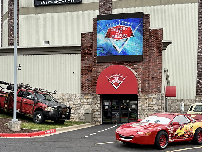 That iconic red awning marks the spot where automotive dreams come true. Lightning McQueen's smile says it all&mdash;this isn't your average car collection.