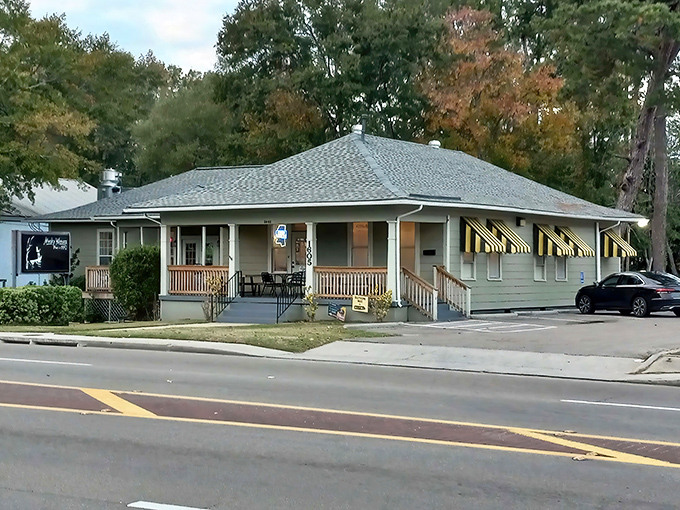 Autumn leaves frame this barbecue sanctuary like nature's own Instagram filter. The yellow-striped awnings add a touch of whimsy.