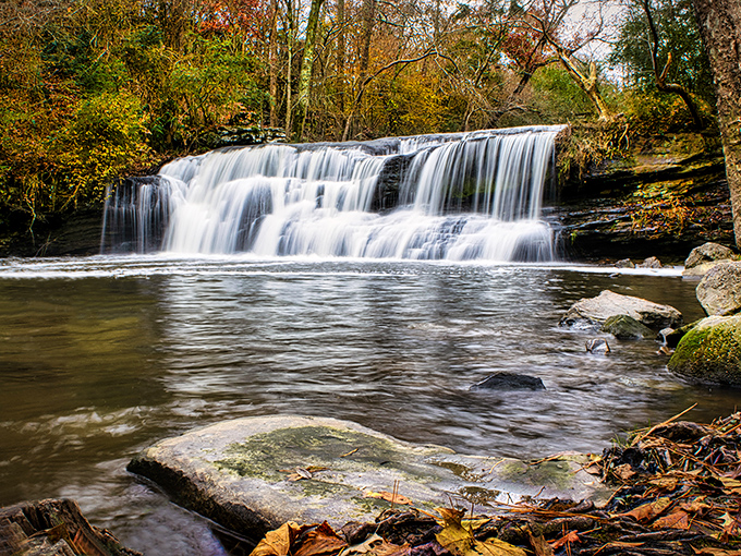 Fall foliage frames the falls like nature's own Instagram filter, no editing required whatsoever.
