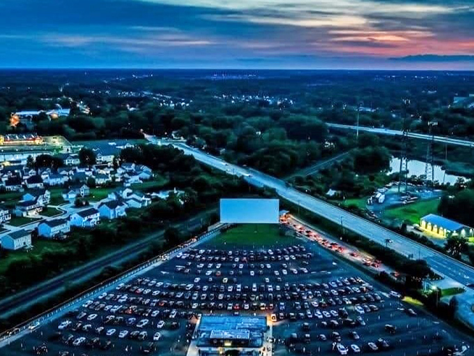 From above, the drive-in resembles a constellation of headlights, each vehicle a star in this uniquely American galaxy of entertainment.