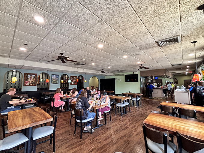 Inside, warm wood tones and soft lighting create the perfect backdrop for animated conversations and serious eating.
