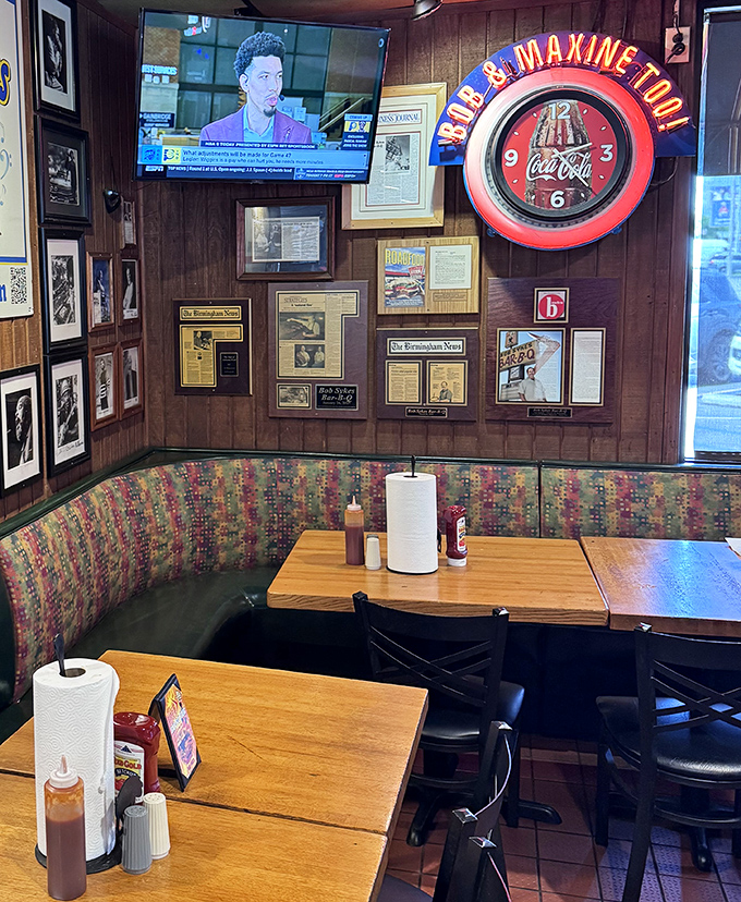 Wood-paneled walls covered in history and that colorful booth upholstery—this isn't interior design, it's a barbecue time machine.