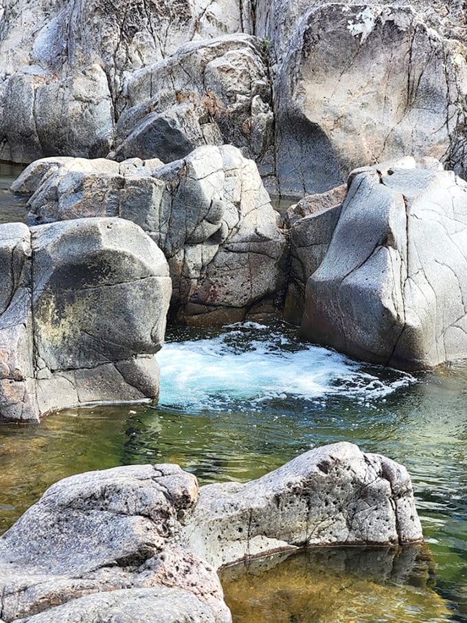 Water rushing between massive boulders creates nature's own spa experience. These smooth chutes have been polished by the Black River for millennia.