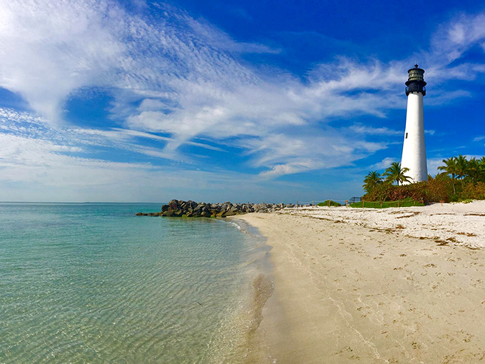 The Cape Florida Lighthouse stands tall like the world's most elegant exclamation point at the end of a perfect beach day.