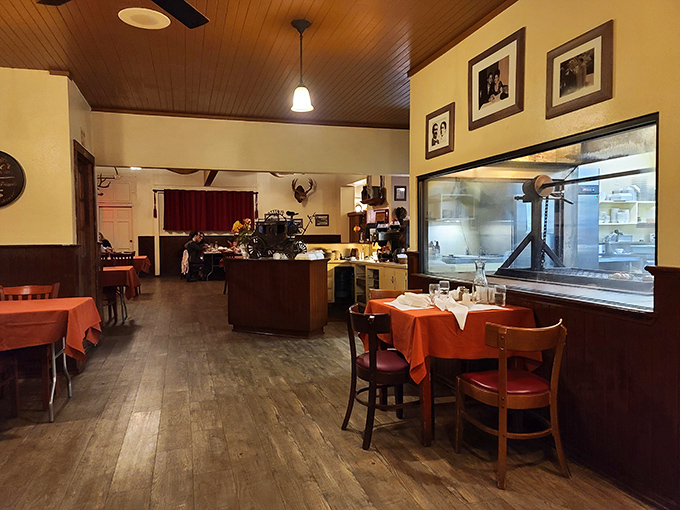Simple elegance defines the dining room, where wooden ceilings and orange tablecloths create the perfect backdrop for serious steak business.