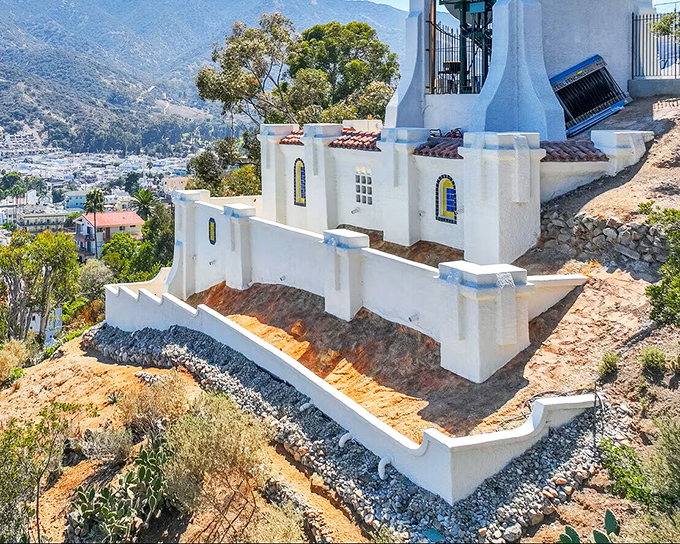 The iconic Catalina Chimes Tower stands sentinel above Avalon, its whitewashed Mediterranean architecture creating a postcard-perfect silhouette against the island's rugged terrain.