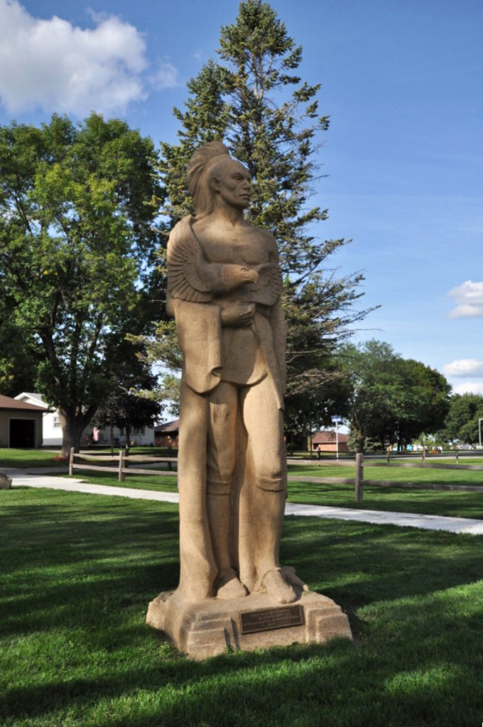 Chief Black Hawk stands sentinel over his namesake waters. This stoic monument reminds visitors of the rich Native American heritage that shaped this tranquil landscape.