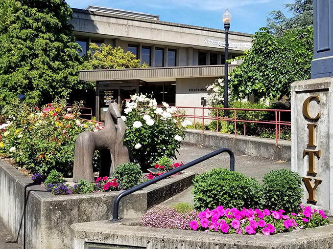 City Hall stands proudly amid vibrant flower displays, proving that civic pride and gardening skills go hand-in-hand in Roseburg.