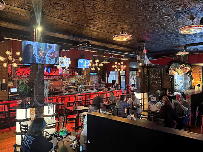 Step inside and the atmospheric red walls, ornate tin ceiling, and horror memorabilia create a dining experience that's equal parts movie set and gourmet getaway.