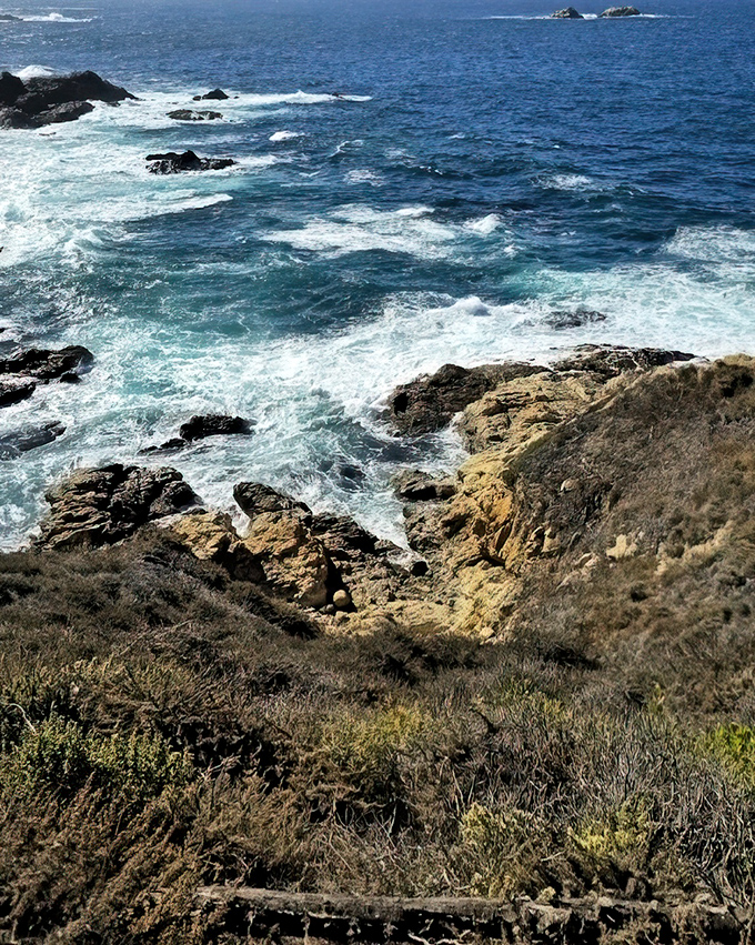 Nature's own infinity pool where rugged meets serene. The Pacific crashes against golden cliffs in a display that puts IMAX to shame.