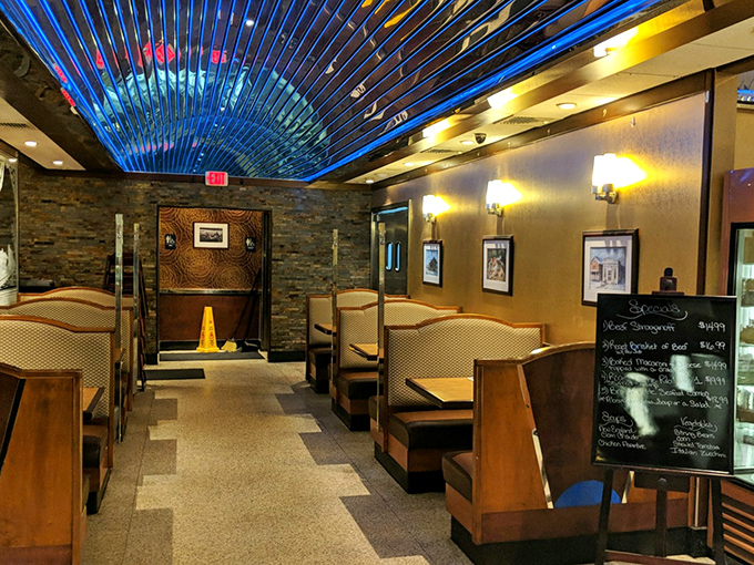 Step inside to discover a dining room where stone accent walls meet comfortable booths, all bathed in that signature blue glow that says "relax, calories don't count here."
