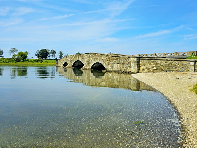 This stone bridge isn't just crossing water &ndash; it's spanning centuries, offering a moment of reflection where Rhode Island's past meets its peaceful present.
