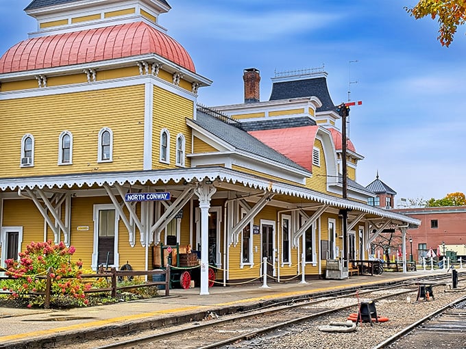 The North Conway Scenic Railroad Station stands as a butter-yellow Victorian time machine, ready to whisk you away on rails of nostalgia.