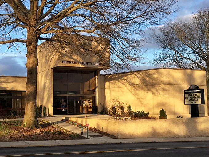 The Putnam County Library stands as a modern sanctuary of knowledge, where sunlight plays across its distinctive fa&ccedil;ade at golden hour.
