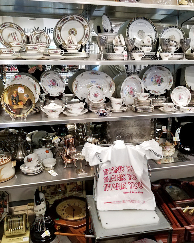 Grandma's china cabinet has nothing on this display! Delicate teacups and vintage plates wait patiently for their second act in someone's home.