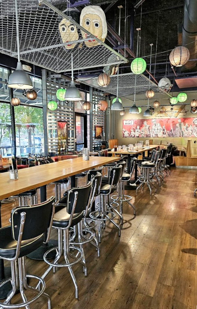 Industrial-chic meets horror movie set. Paper lanterns cast an eerie glow while zombie art watches you eat&mdash;somehow making everything taste better.