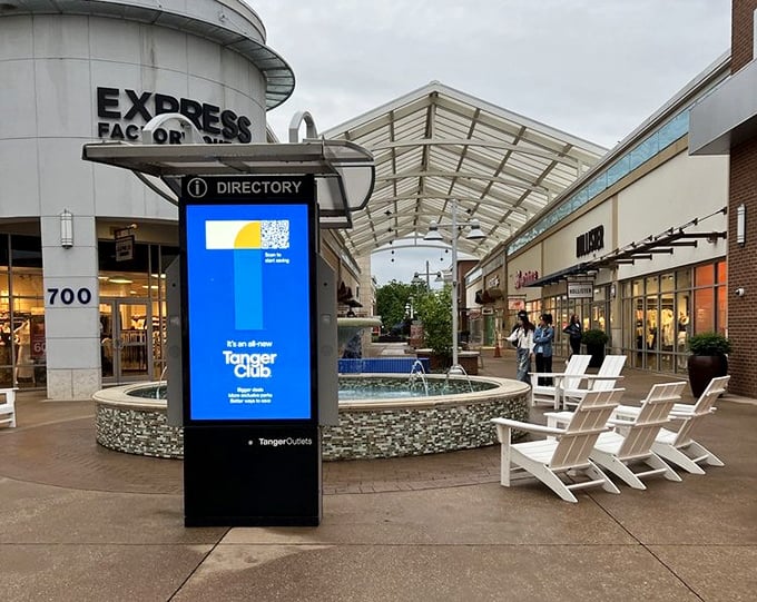 This isn't just a directory&mdash;it's a treasure map. The fountain and Adirondack chairs create a perfect resting spot for weary bargain hunters between retail victories.