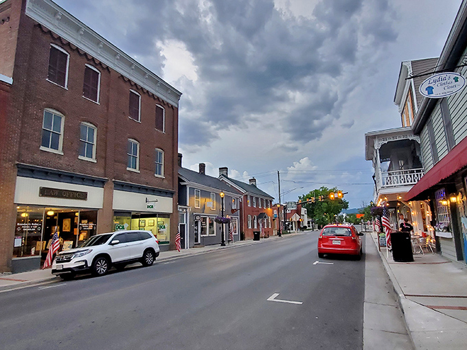 Dusk settles over King Street like a gentle blanket, transforming brick facades into a warm tableau that Norman Rockwell would've rushed to paint.