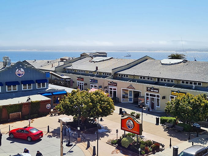 The same stunning view of Monterey's coastal buildings, where the blue bay stretches to the horizon and every window frame captures a million-dollar panorama.
