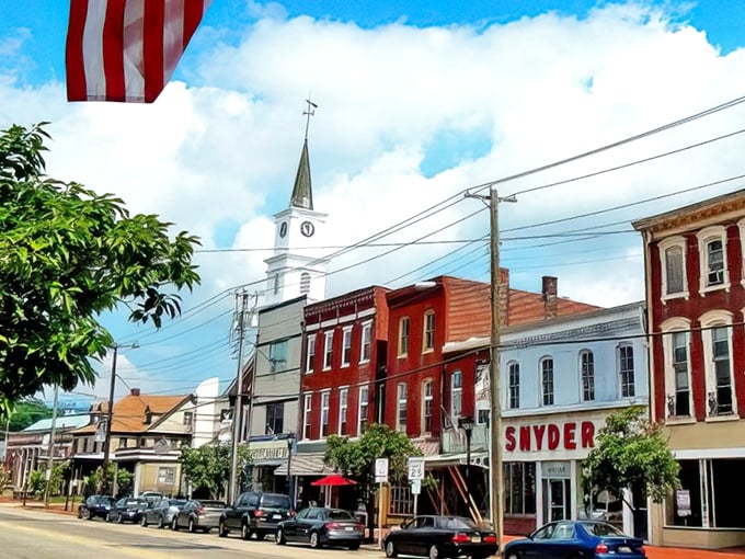Broadway's historic facades tell stories older than your favorite vinyl records, with that church steeple standing sentinel over simpler times.