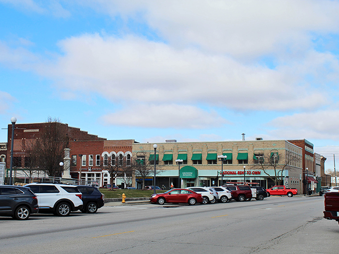 Downtown Lincoln's historic storefronts stand like a living museum where commerce and history shake hands daily. The green awnings add a touch of small-town elegance to this quintessential Midwestern main street.
