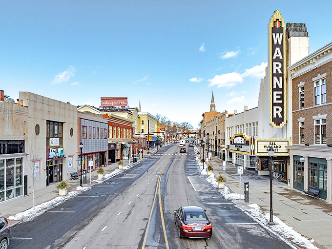 The Warner Theatre marquee stands tall like a beacon of culture in northwestern Connecticut's rolling hills.