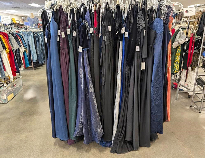 A rainbow of formal wear awaits its second dance, each gown whispering tales of proms and special occasions past while awaiting new memories.