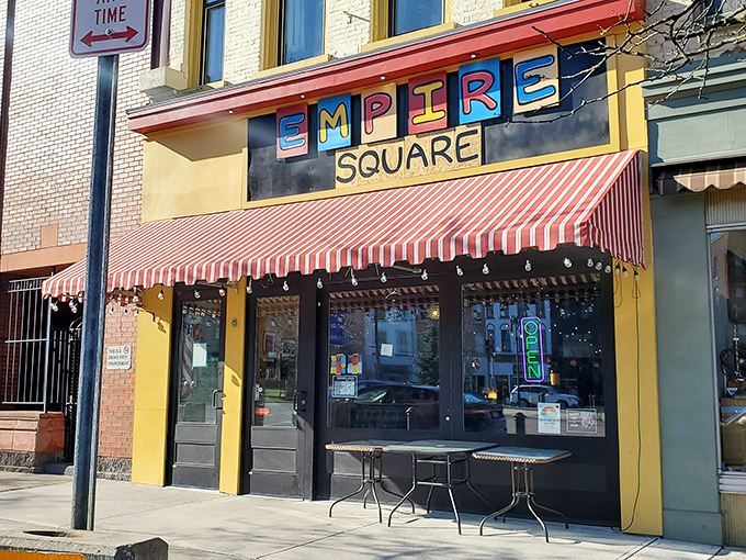 Empire Square's vibrant facade and striped awning beckon like an old friend, promising craft brews and conversations that flow as smoothly as the beer.