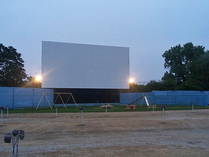 As day fades to night, the massive screen comes alive with light, transforming an ordinary field into a temple of storytelling.