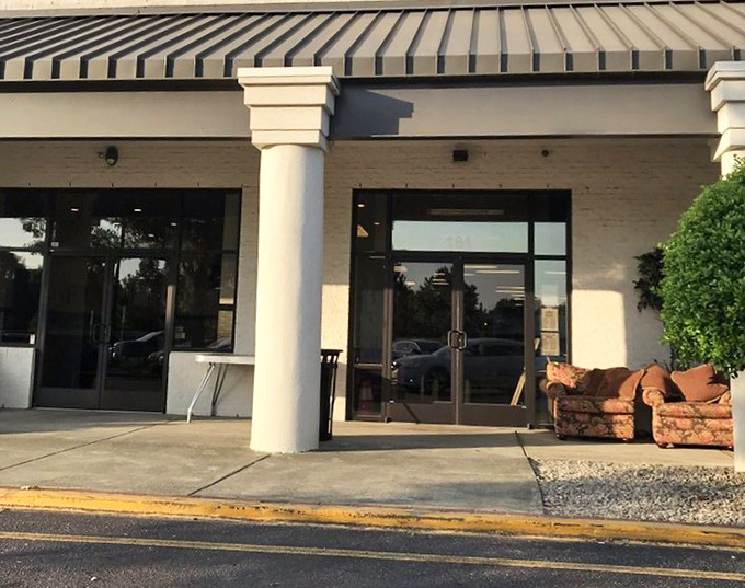 That couch outside isn't just furniture&mdash;it's a preview of the adventures awaiting inside. The thrift shop's welcoming entrance sets the tone for treasure hunting.