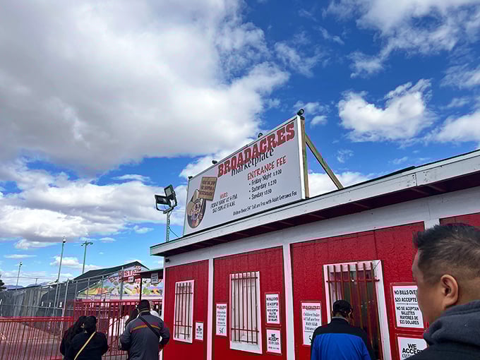 The iconic red entrance building stands like a portal to bargain paradise, welcoming weekend warriors under Nevada's expansive blue skies.