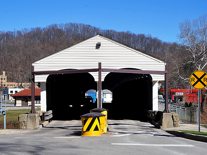 Step into history's time machine! The bridge's entrance beckons travelers through its wooden portal, promising stories from another century just beyond those shadowy arches.