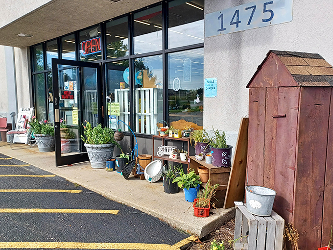 The entrance beckons with rustic charm &ndash; galvanized buckets, garden tools, and that weathered barn door practically whispering "come find something wonderful inside."