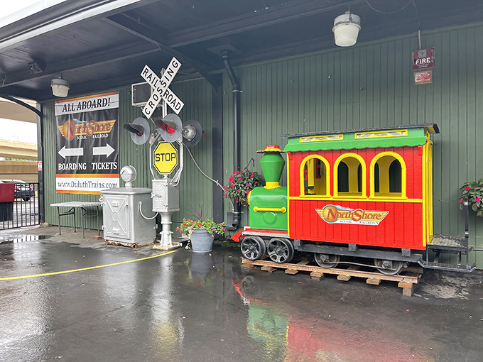 The boarding area's colorful mini-train welcomes visitors with a cheerful "All Aboard!" &ndash; like a Wes Anderson film set come to life.