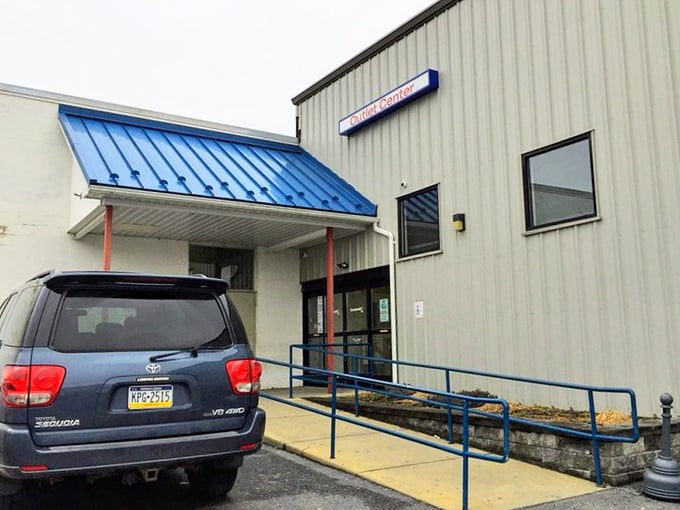Blue skies and bargain hopes hover above this thrifter's paradise. The entrance may look ordinary, but beyond those doors lies an extraordinary shopping adventure.