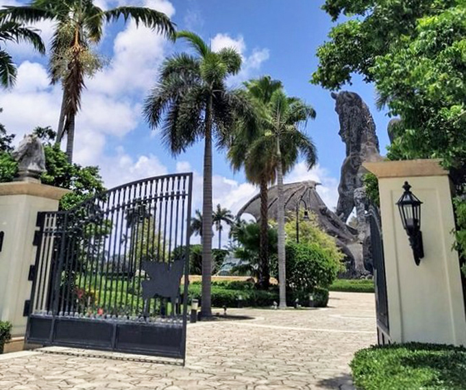 The grand entrance beckons visitors through elegant gates, offering tantalizing glimpses of the mythical confrontation beyond.