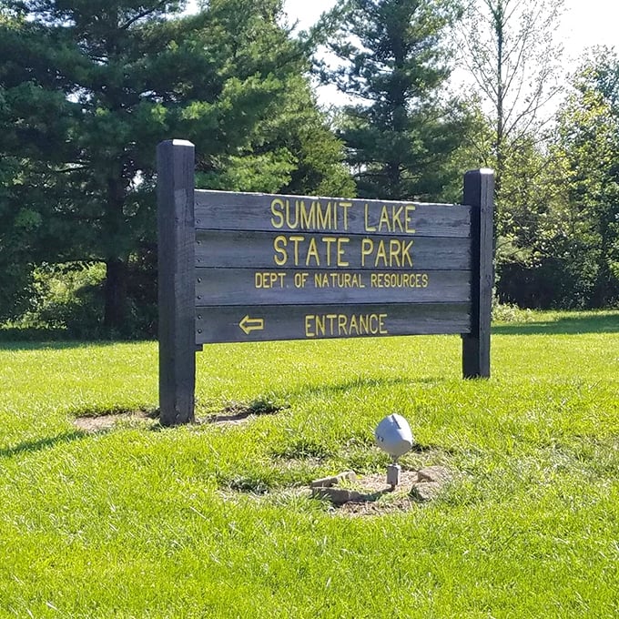 The entrance sign stands like a humble gatekeeper to paradise. No flashing lights or billboards needed when what lies beyond speaks for itself.
