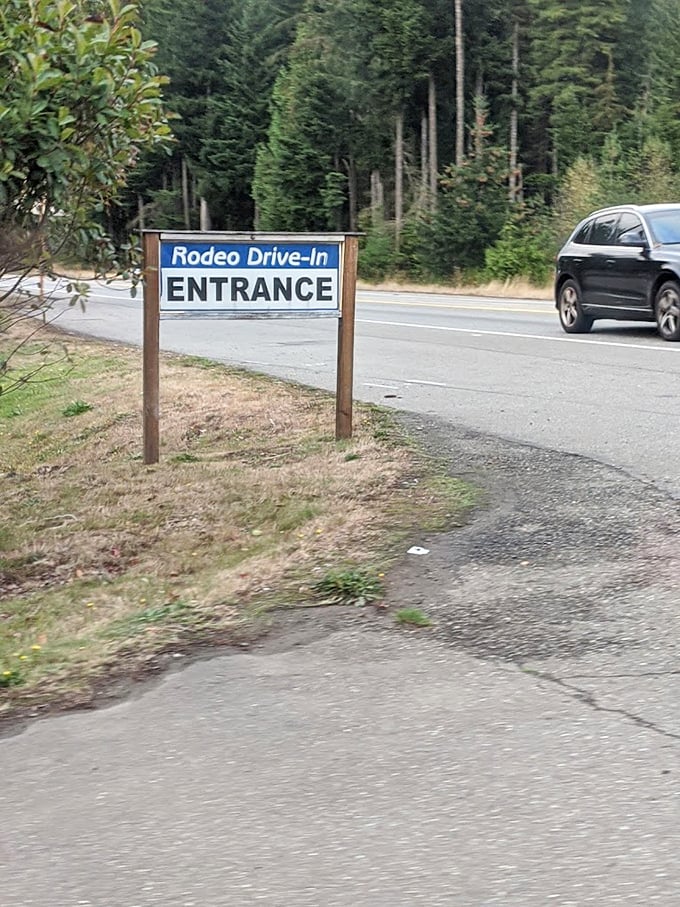 The unassuming entrance sign stands like a portal to the past, promising an evening of nostalgia that no streaming service can deliver.