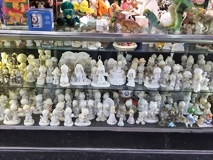 A battalion of Precious Moments figurines stands at attention, their wide-eyed innocence a stark contrast to the haggling happening just feet away.