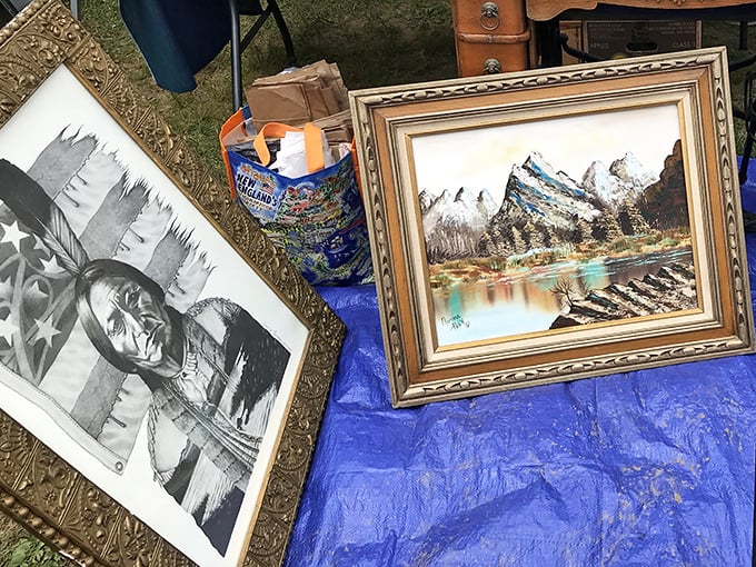 Framed landscapes and vintage prints rest on purple cloth, waiting to transform someone's blank wall into conversation-starter territory.