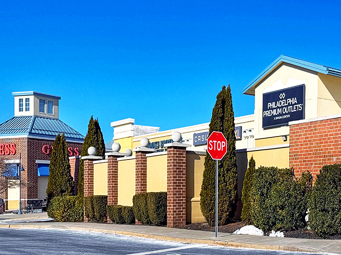 Yellow walls and vibrant storefronts create a cheerful backdrop for serious shopping. Even the stop sign can't slow down determined bargain hunters.