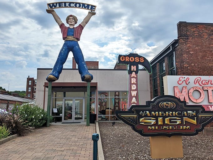 The ultimate greeter: a giant "muffler man" holding a welcome sign, proving size does matter when making first impressions.